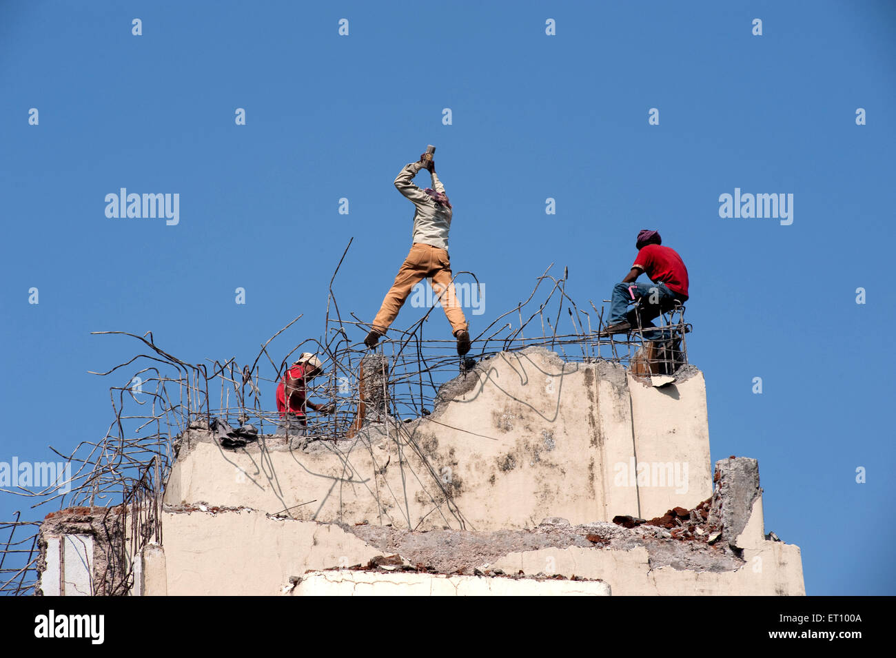 Labour breaking wall of building ; Bombay Mumbai ; Maharashtra ; India ...