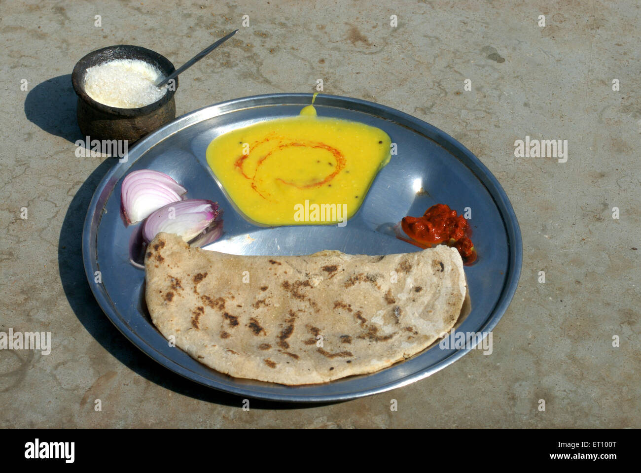 Maharashtrian meal ; zunaka bhakari served with dahi in earthen pot ...