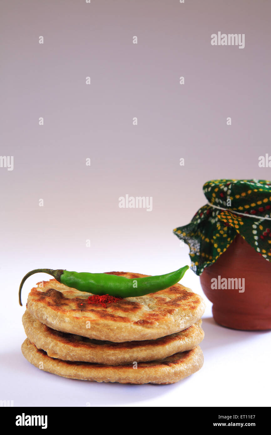 Bhakri jowar bread with green chilli and buttermilk in earthen pot ...