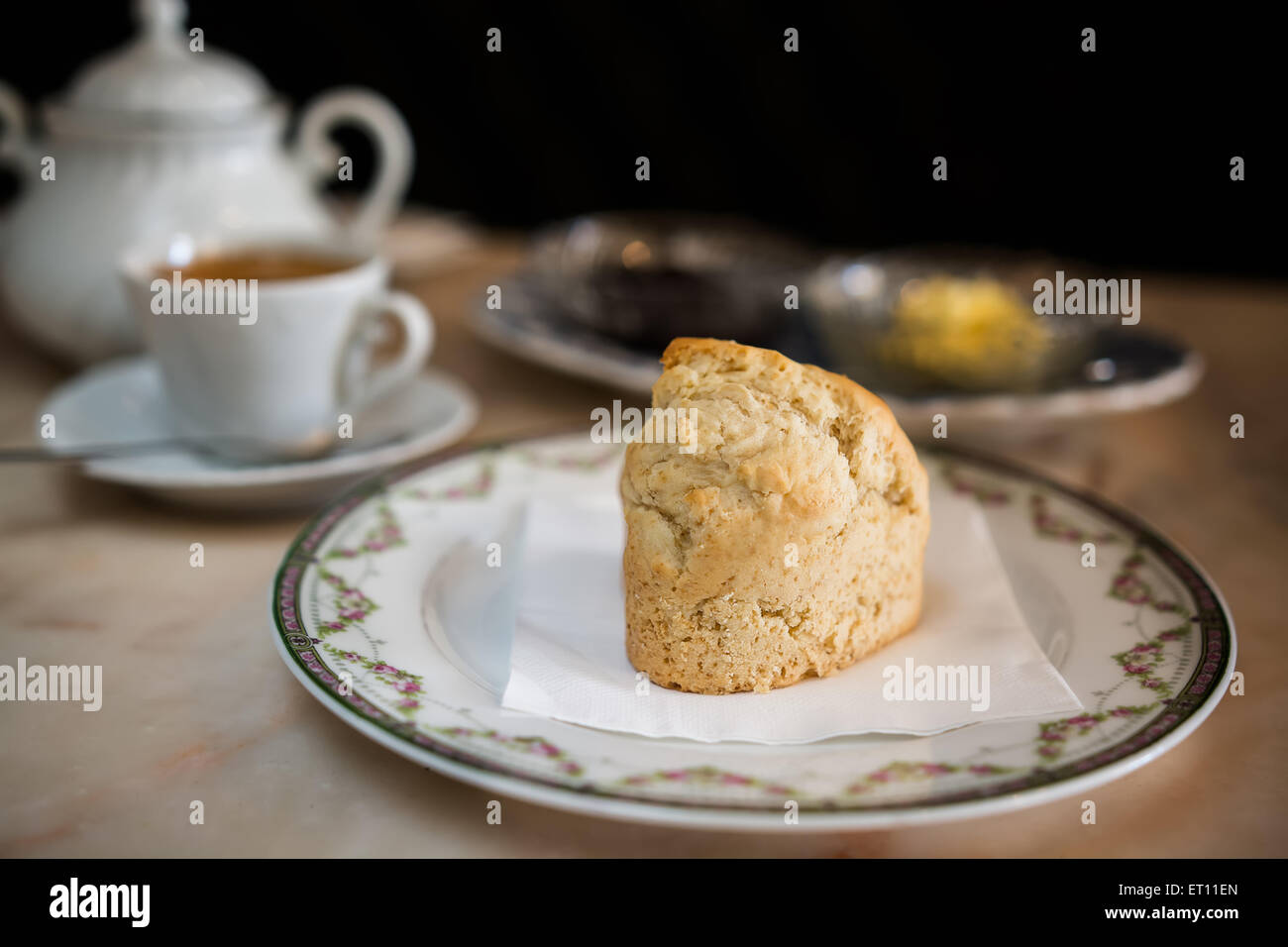 Scone with gelly, butter ant tea Stock Photo - Alamy