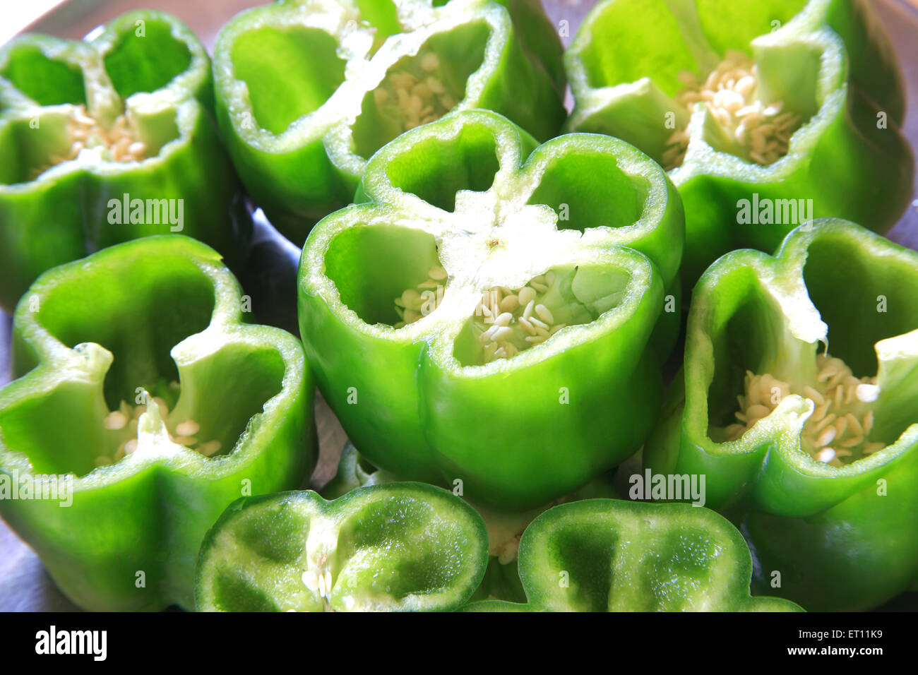 Spices ; half cut green chillies capsicum shimla mirch capsicum annuum ...