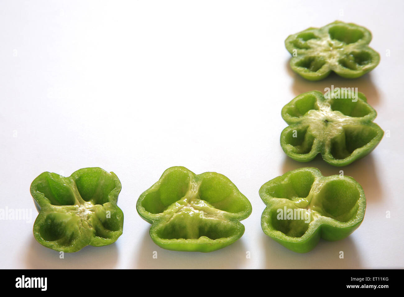 Spices ; half cut green chillies capsicum shimla mirch capsicum annuum ...