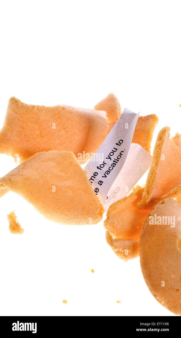 Fortune cookie broken into many pieces with fortune inside showing ...