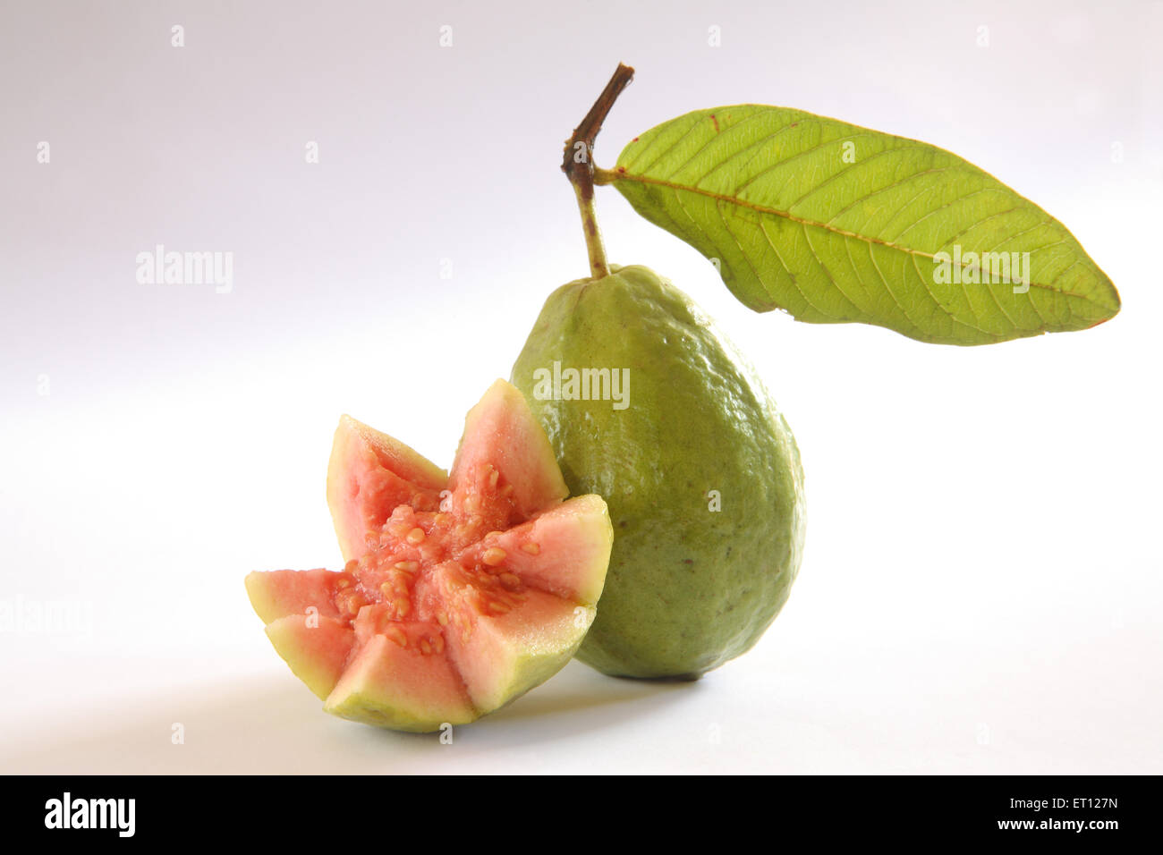 Fruits ; amrood one full and half guava psidium guyava with green leaf ...