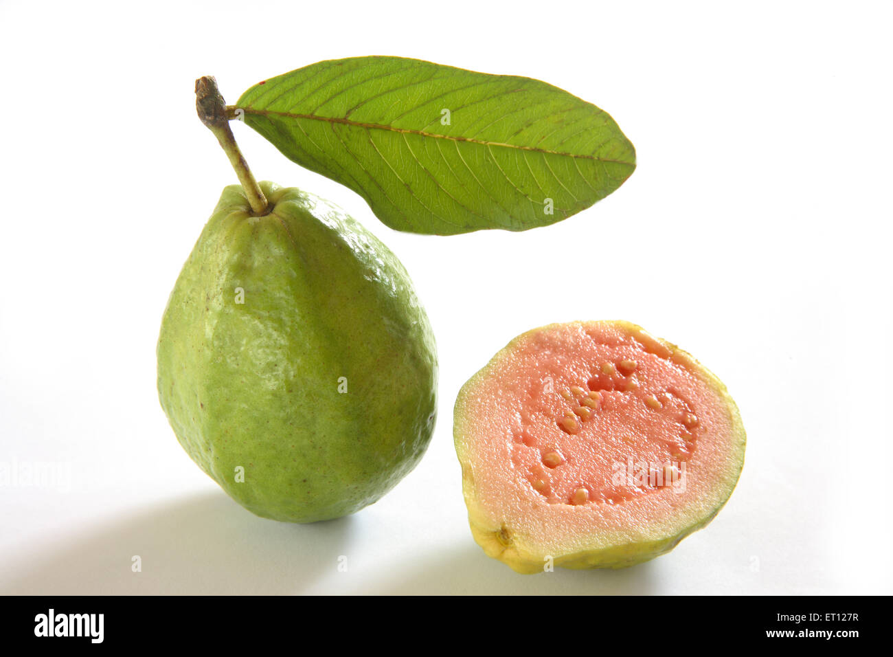 Fruits ; amrood one full and half guava psidium guyava with green leaf ...