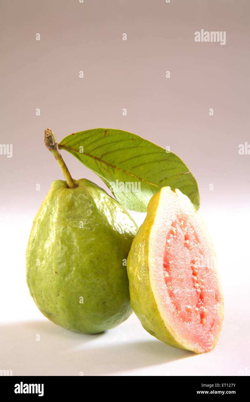 Fruits ; amrood one full and half guava psidium guyava with green leaf ...