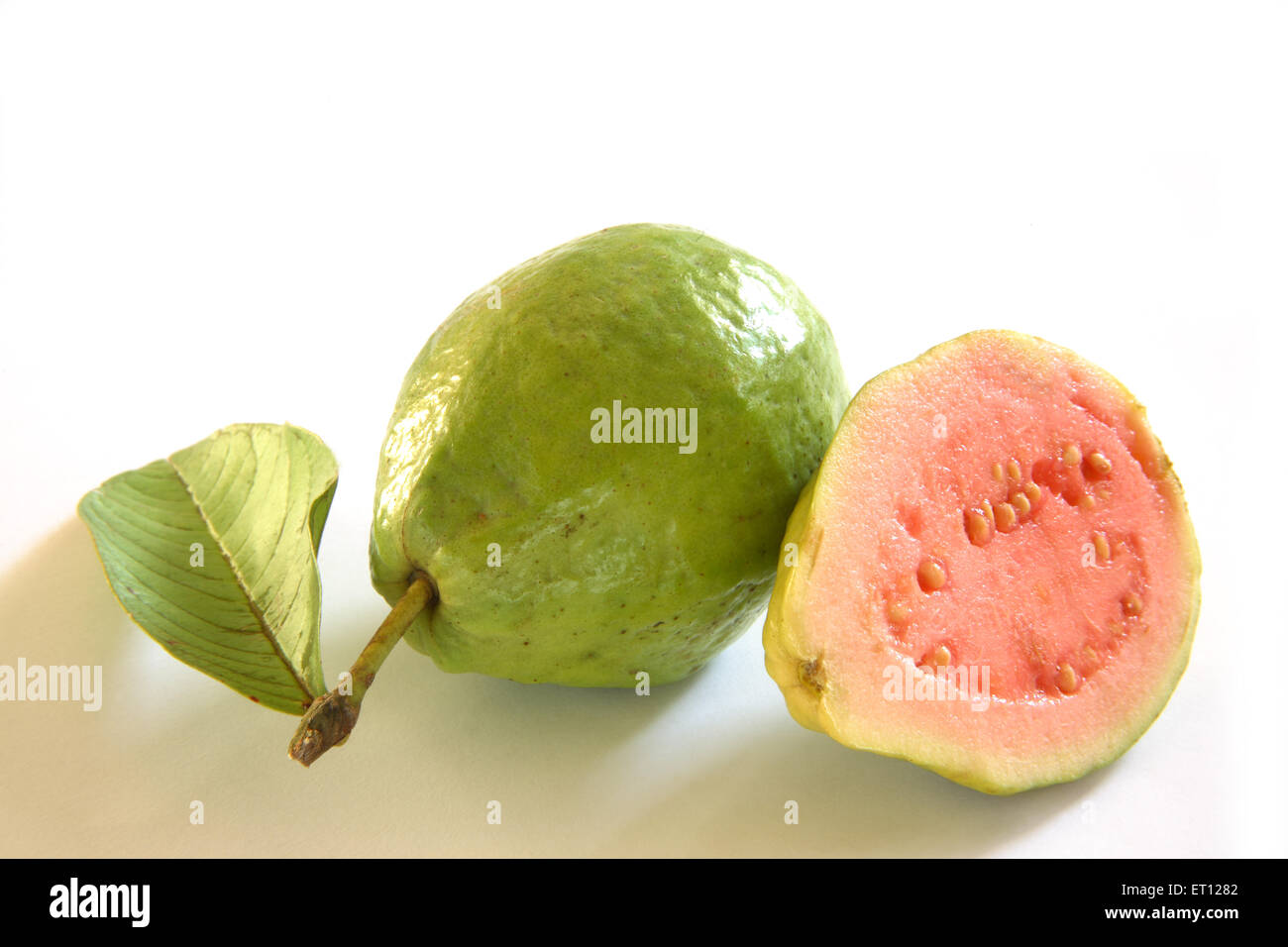 Fruits ; amrood one full and half guava psidium guyava with green leaf ...