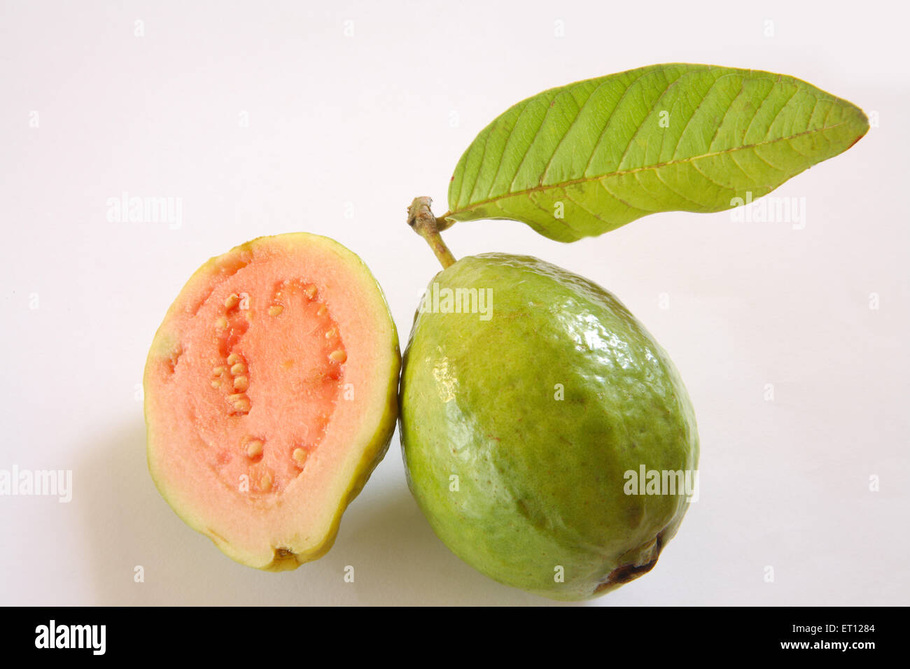 Fruits ; amrood one full and half guava psidium guyava with green leaf ...