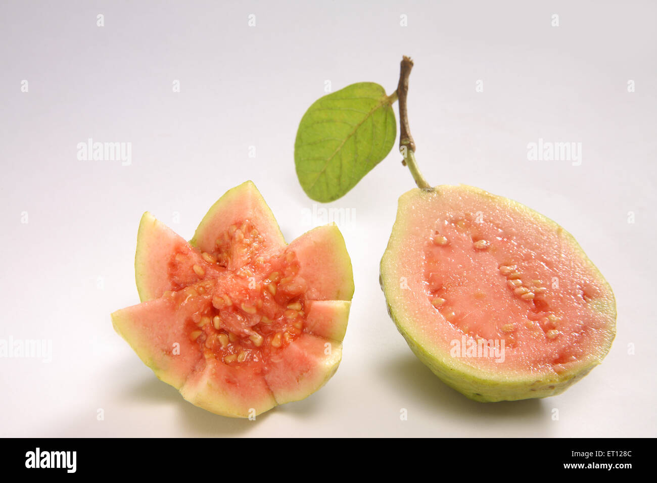 Fruits ; amrood half guava psidium guyava with green leaf on white ...