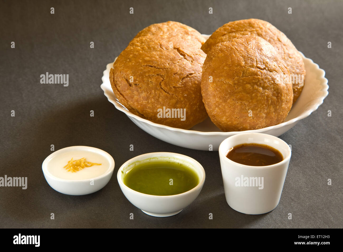 Indian snack fried shahi khasta kachori chaat in bowl yogurt green ...