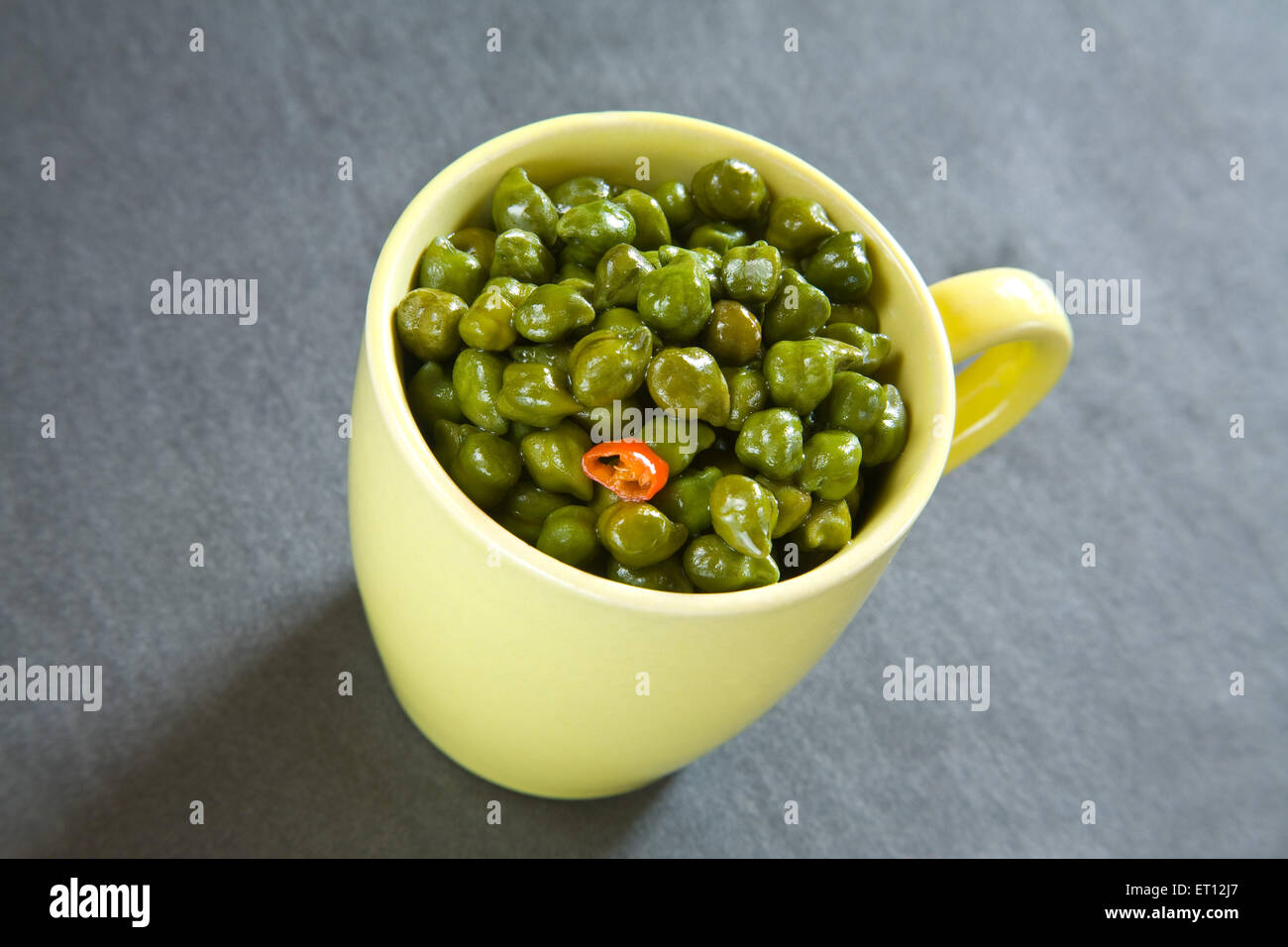 Indian breakfast green chickpeas chana salad served in mug on black ...