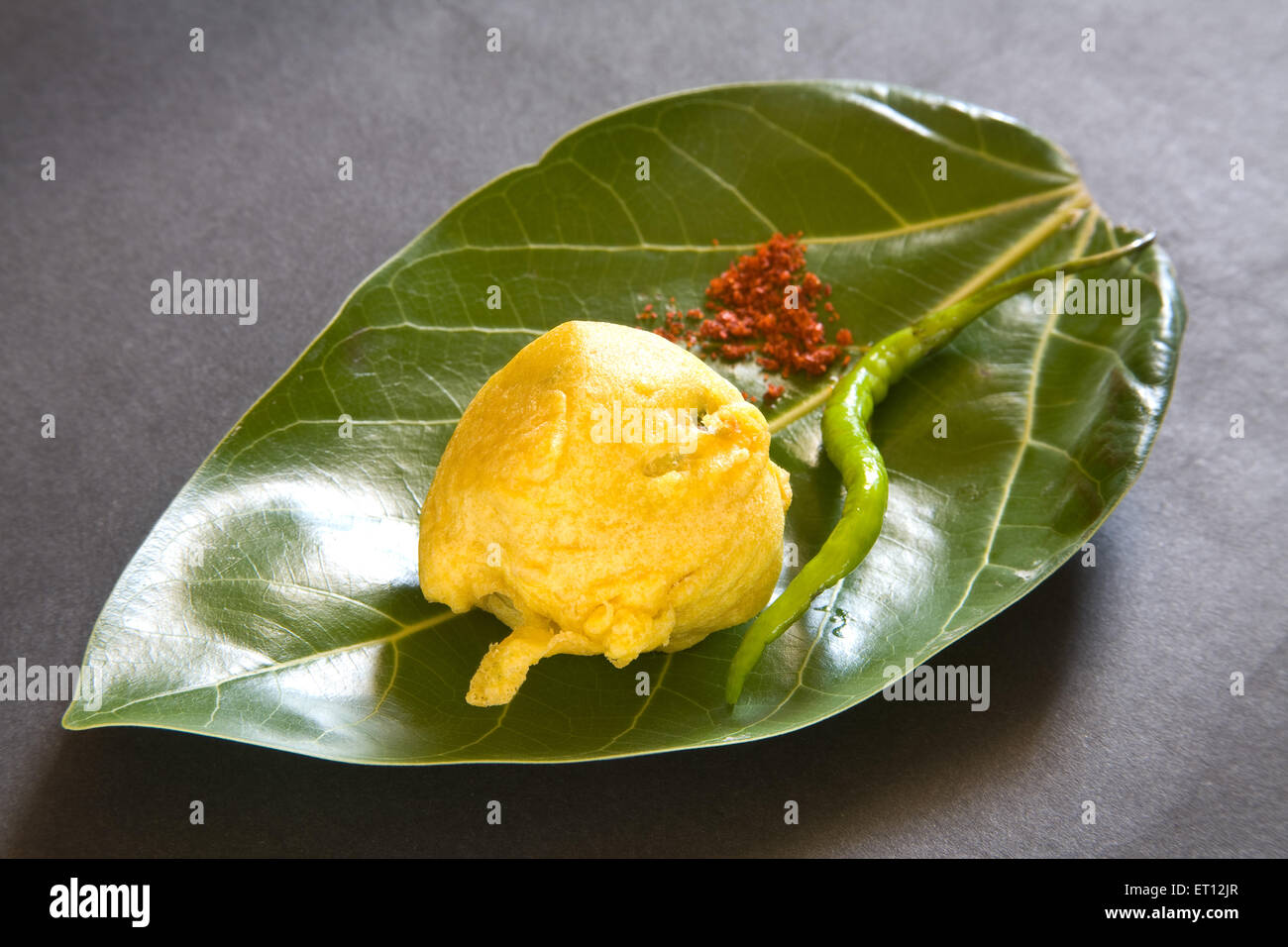 Indian fast food fried batata potato vada with green chilli and red ...