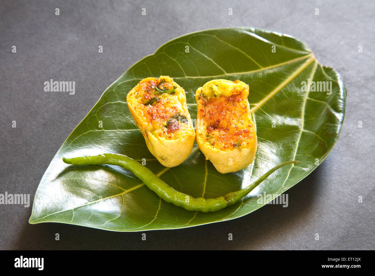 Indian fast food fried batata potato vada with red chutney and green ...
