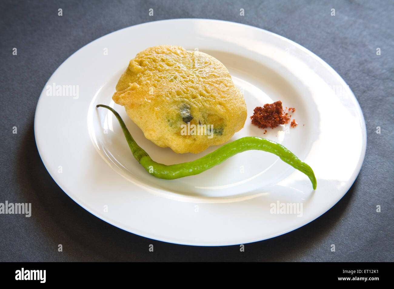 Indian fast food fried batata potato vada with red chutney and green ...
