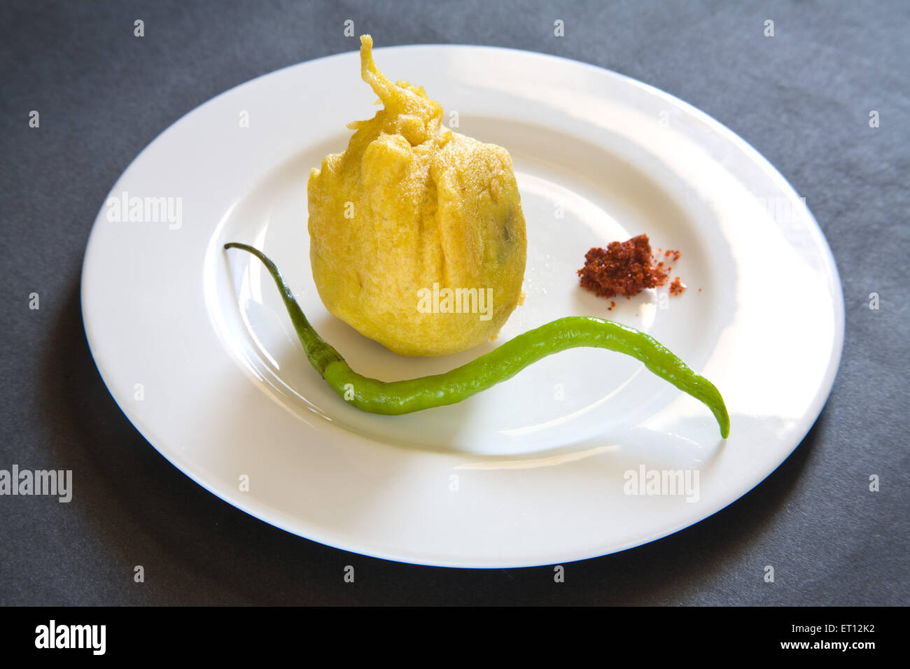 Indian fast food fried batata potato vada with red chutney and green ...
