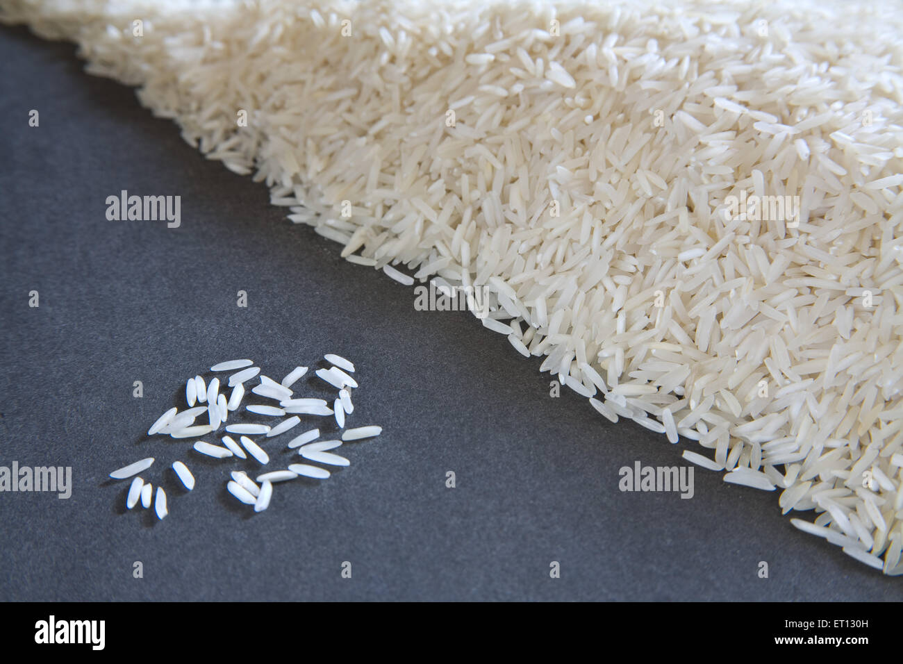 Grains ; basmati rice oryza sativa spread on grey background 20 May ...