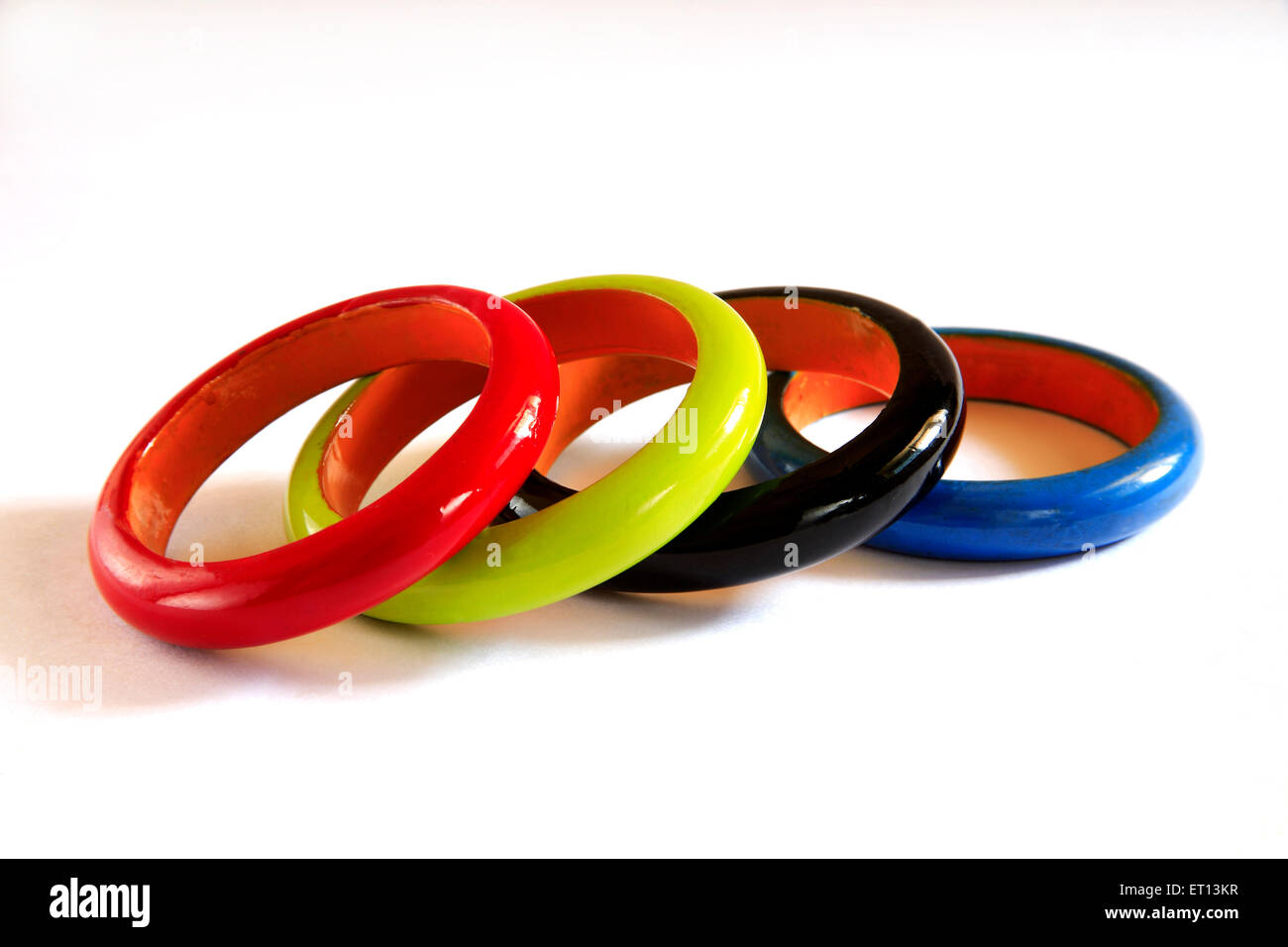 Colorful wooden bangles on white background Stock Photo - Alamy