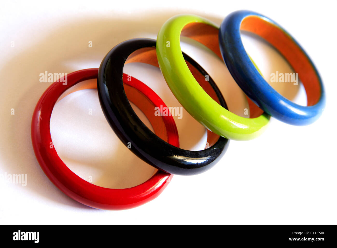 Colorful wooden bangles on white background Stock Photo - Alamy