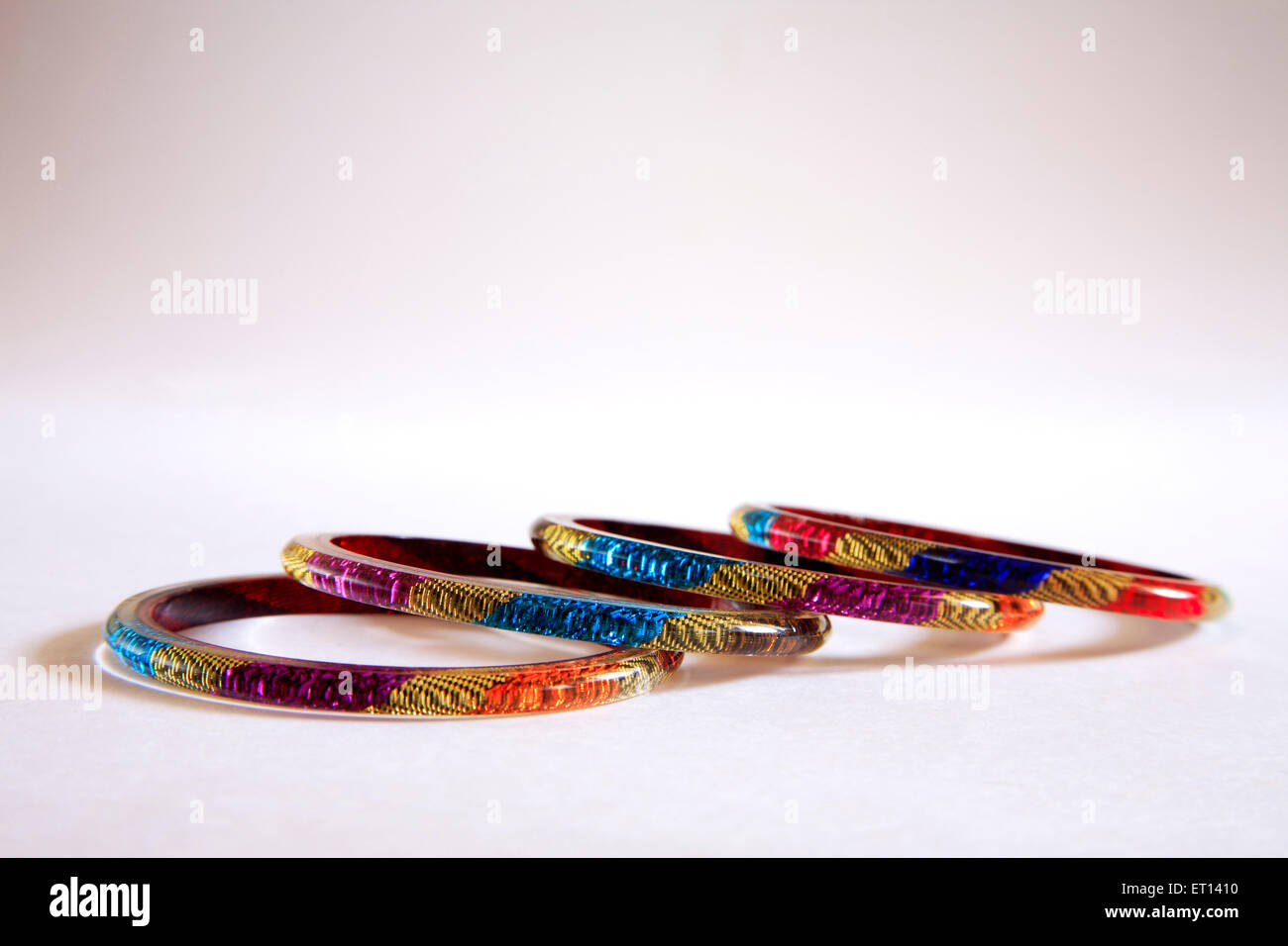 Colorful glass bangles on white background Stock Photo - Alamy