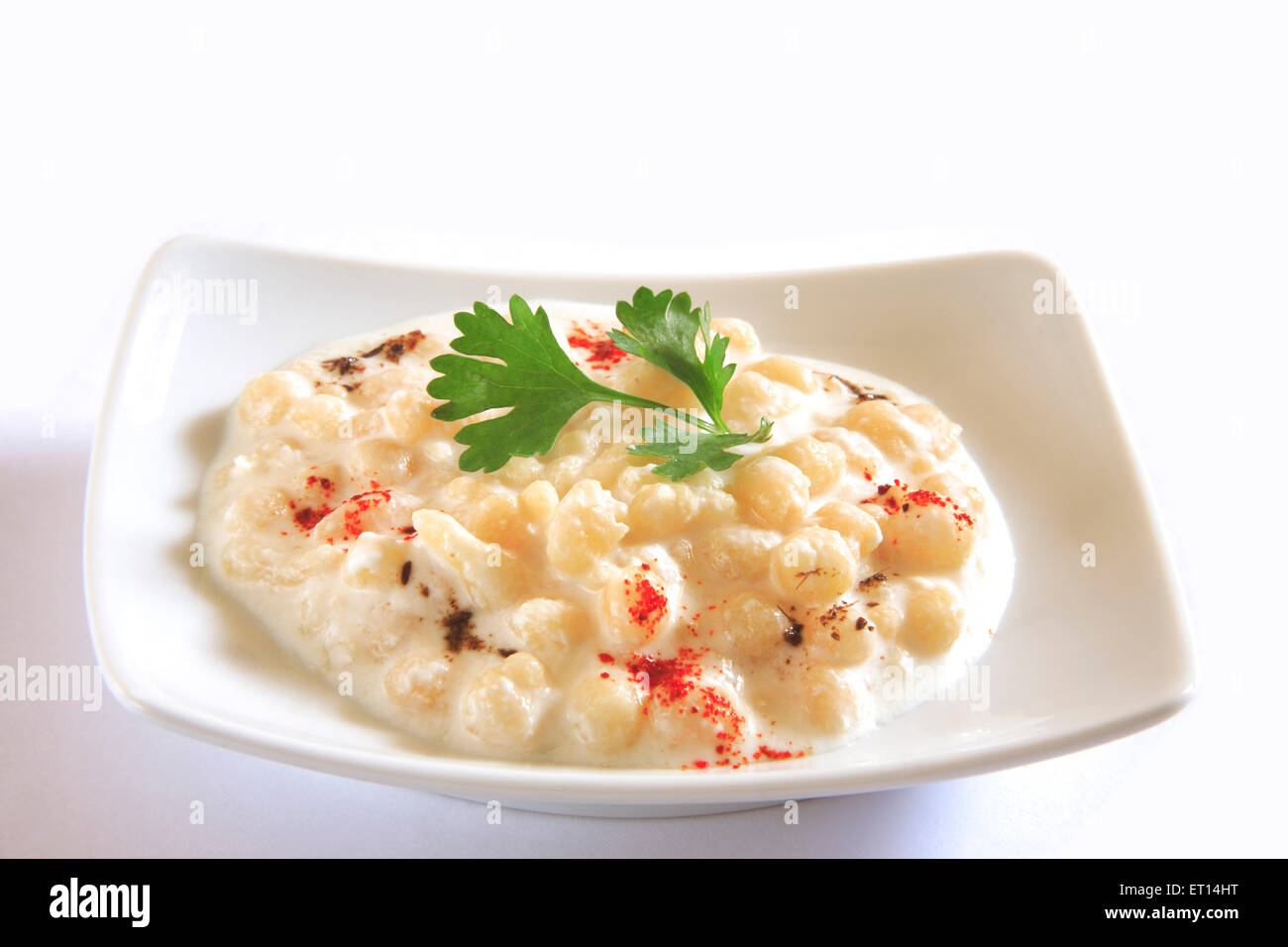 Indian dessert , boondi raita garnish with coriander leaf in rectangle ...