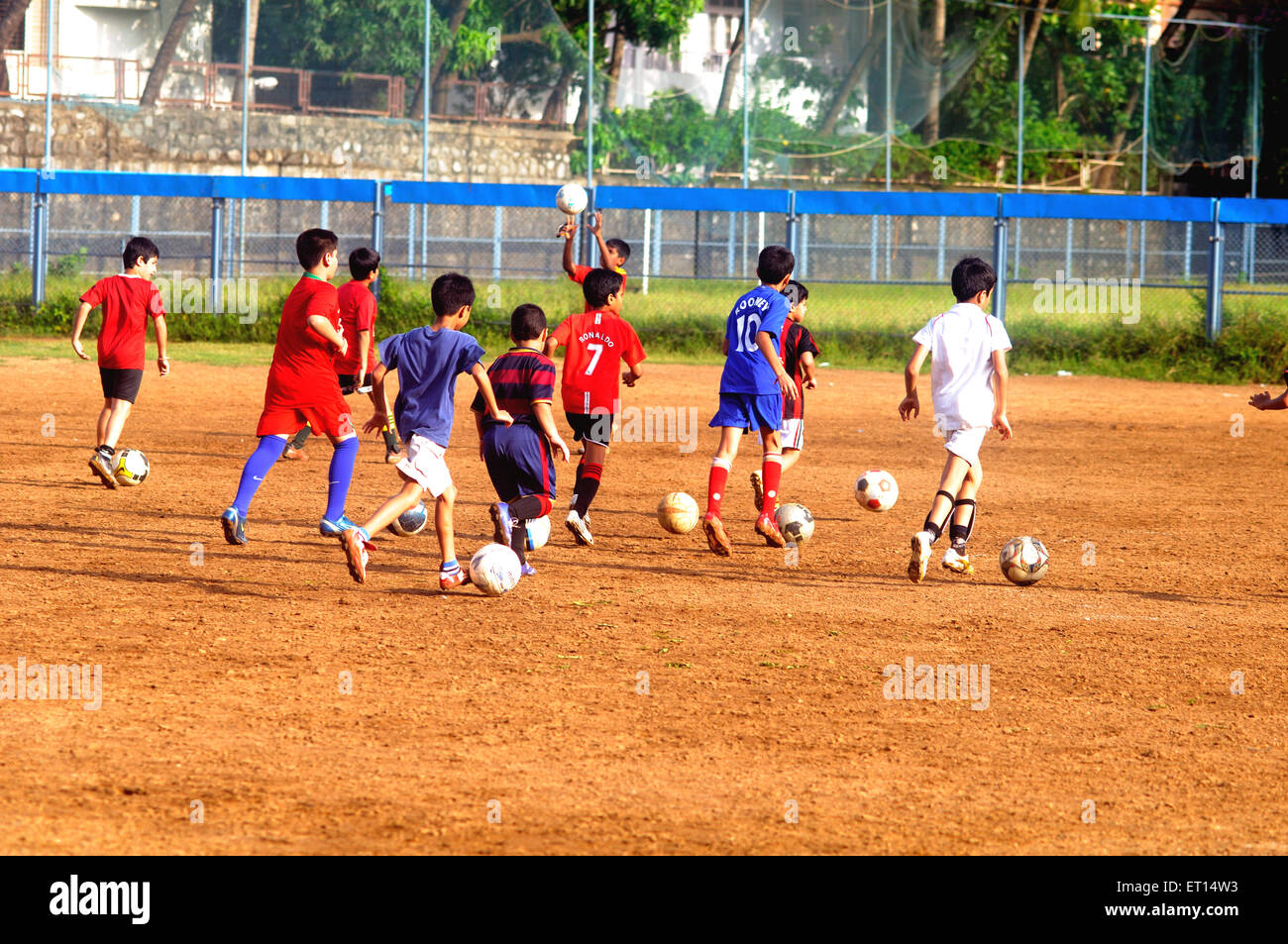 Asian children playing football hi-res stock photography and images - Alamy