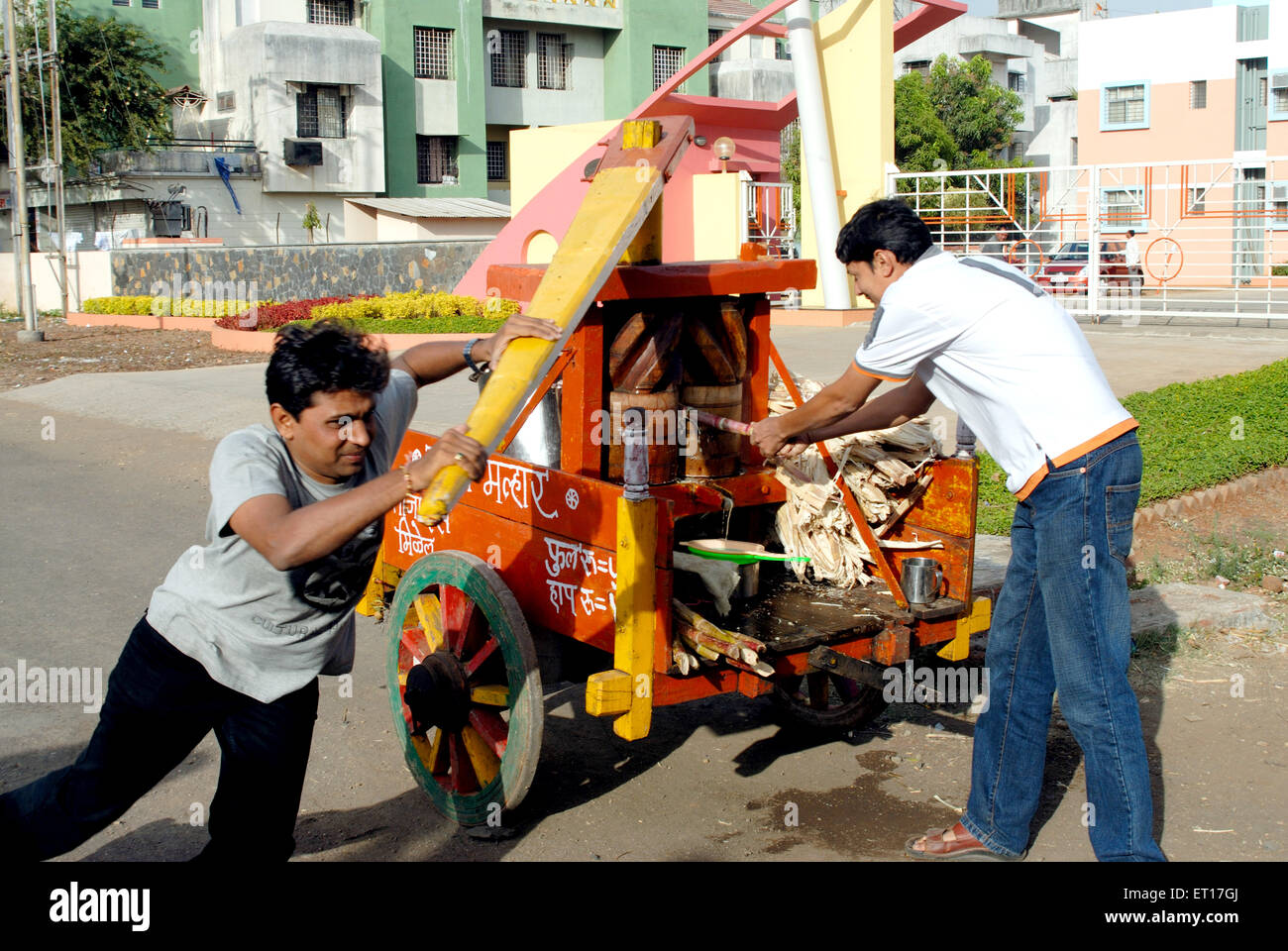 Man extracting sugar cane juice from manual sugarcane juice making ...