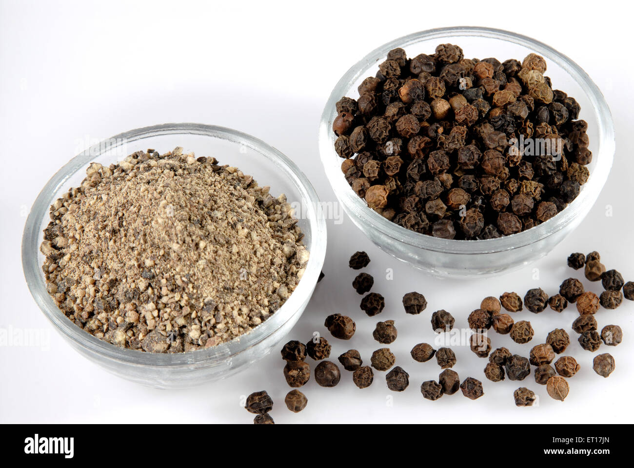 black pepper seeds and powder in glass bowls on white background Stock ...