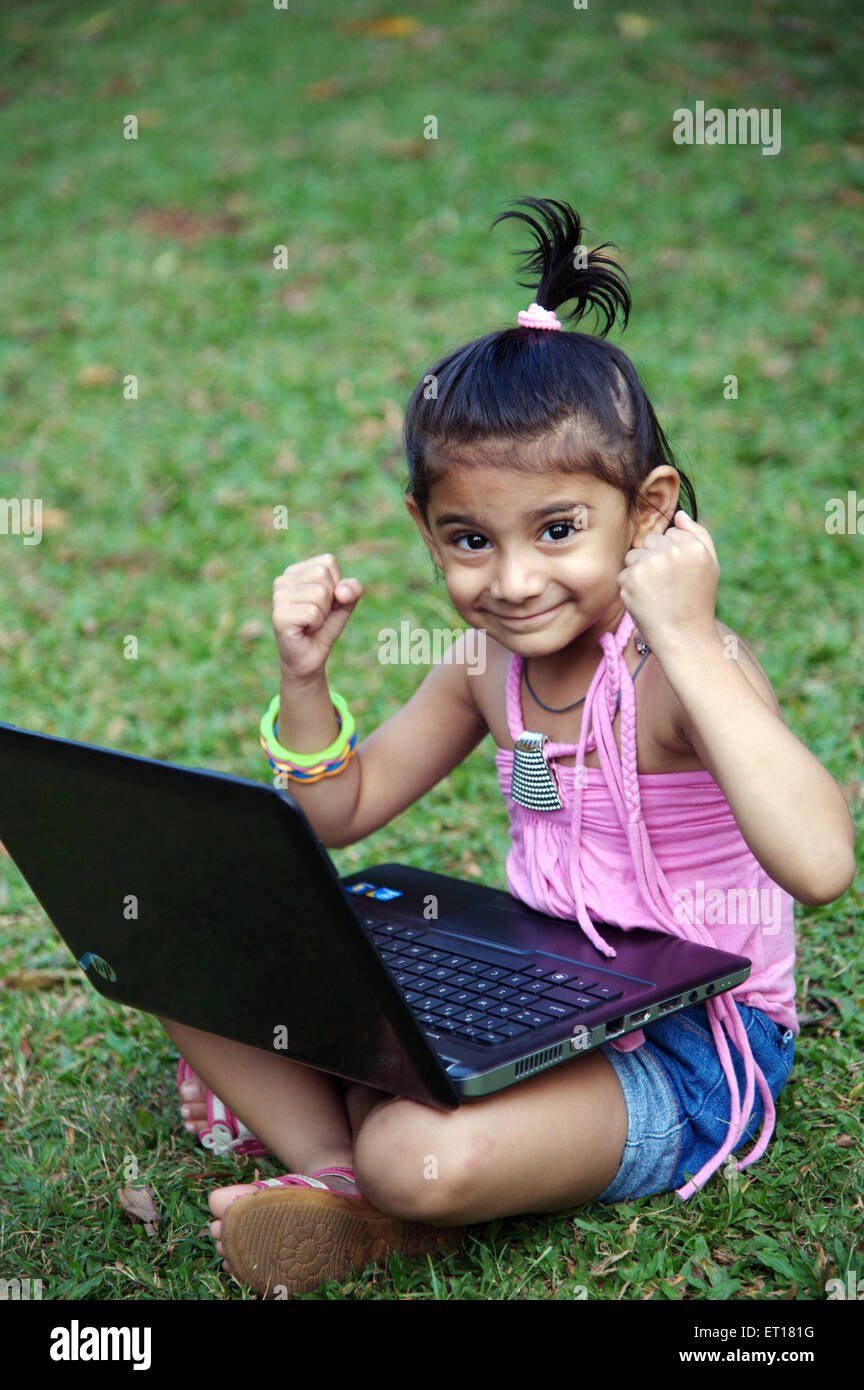 Baby girl working on laptop computer MR#736L Stock Photo - Alamy