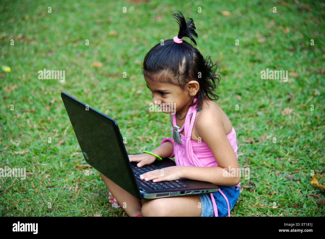 Baby girl working on Laptop computer in garden MR#736L Stock Photo - Alamy