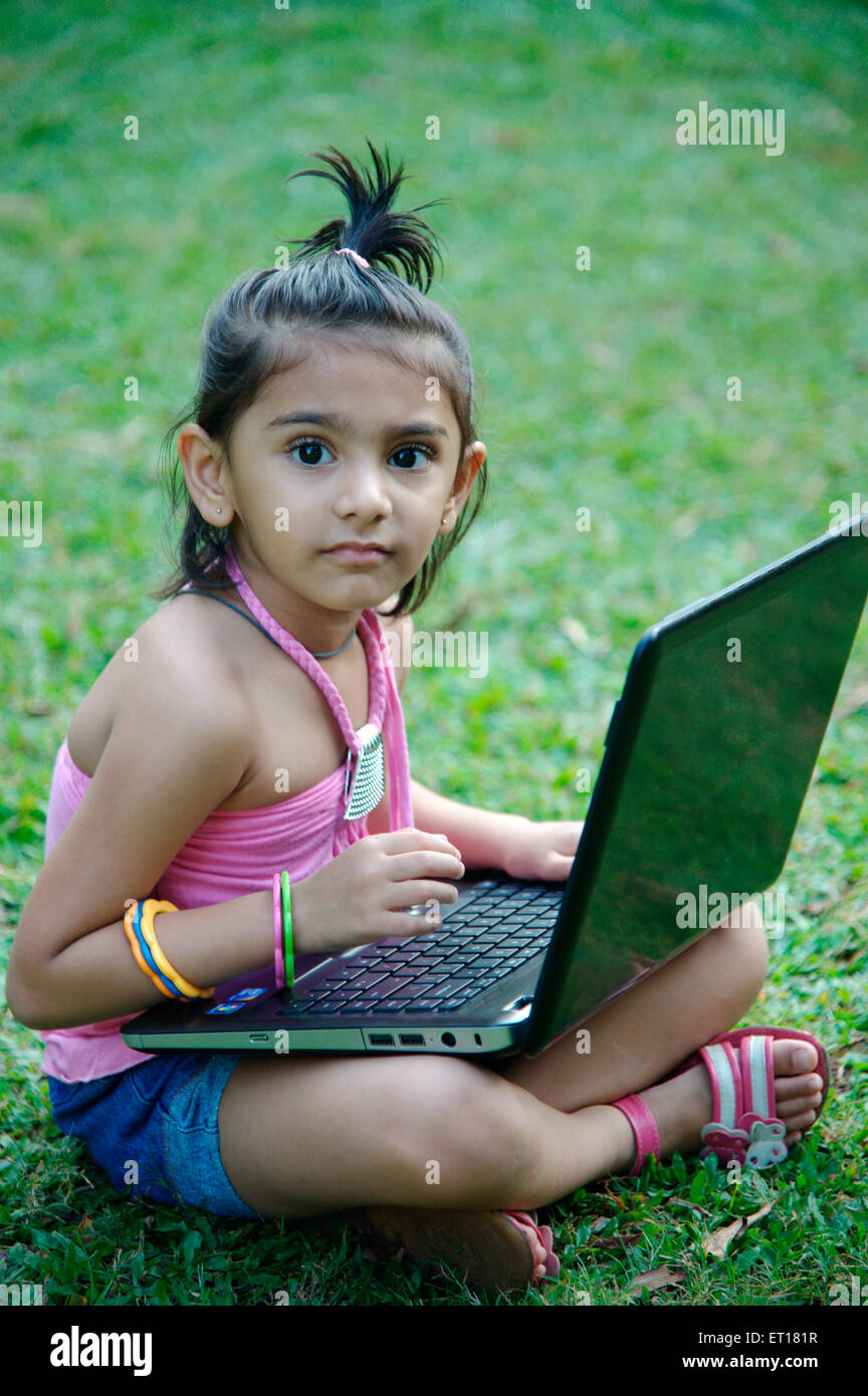 Baby girl working on laptop computer MR#736L Stock Photo - Alamy