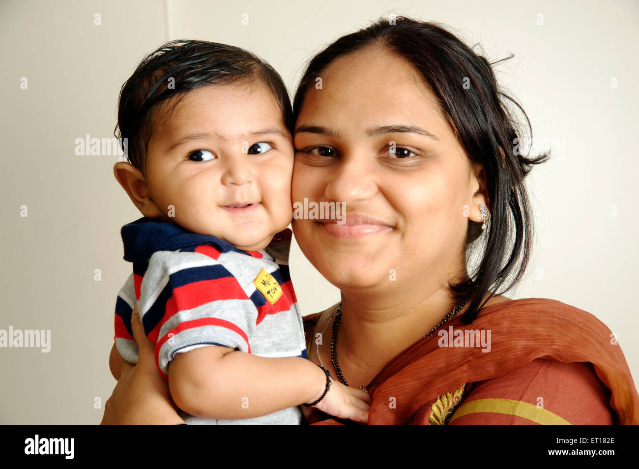 Indian mother and baby boy child cheeks touching white background - MR ...