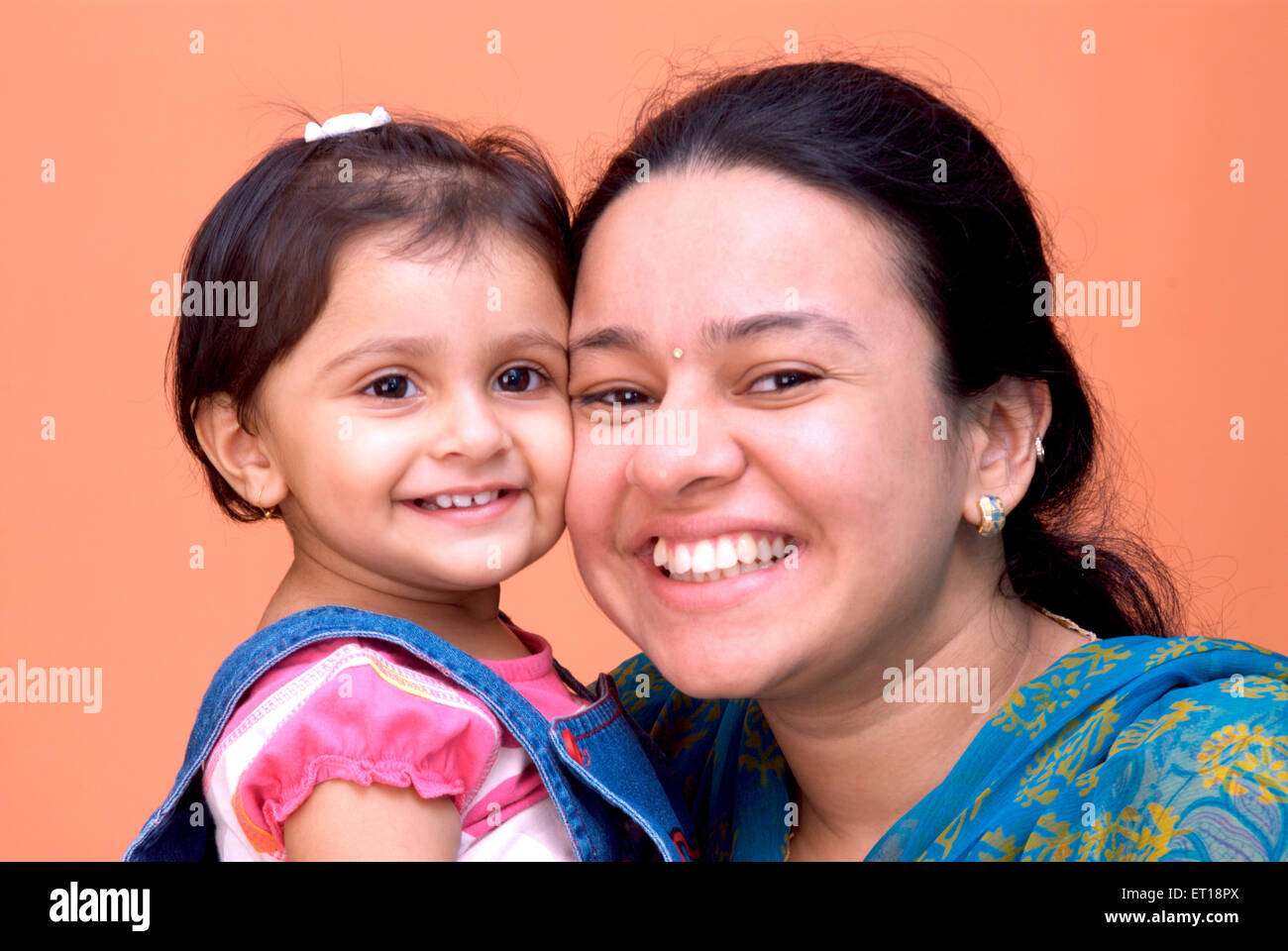 Indian mother and baby girl child cheeks touching happy laughing - MR ...
