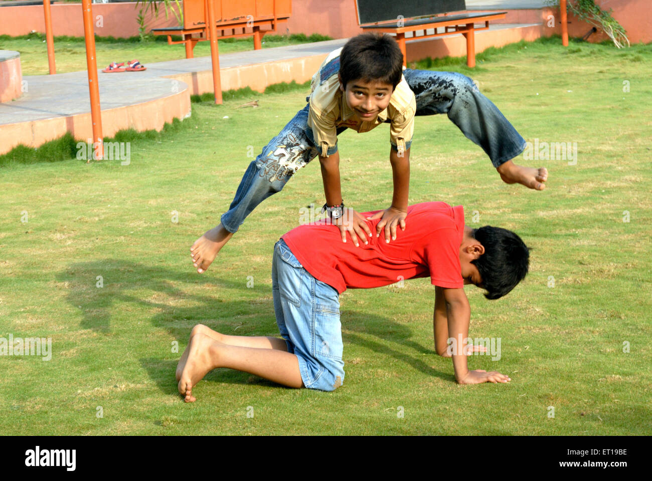 Boy jumping over friend - MR#152 and MR#364 Stock Photo - Alamy