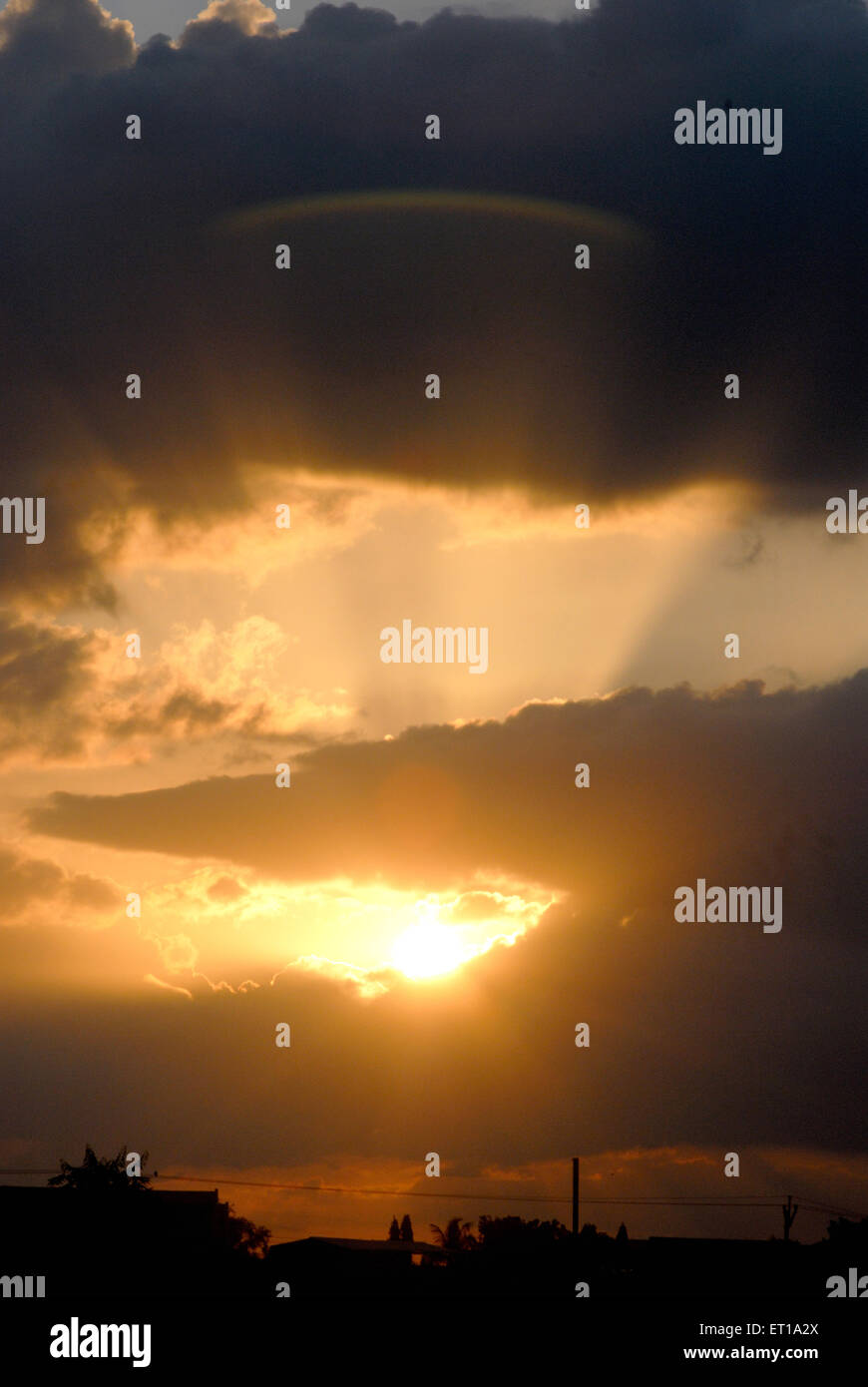 Sun hiding behind clouds Stock Photo - Alamy