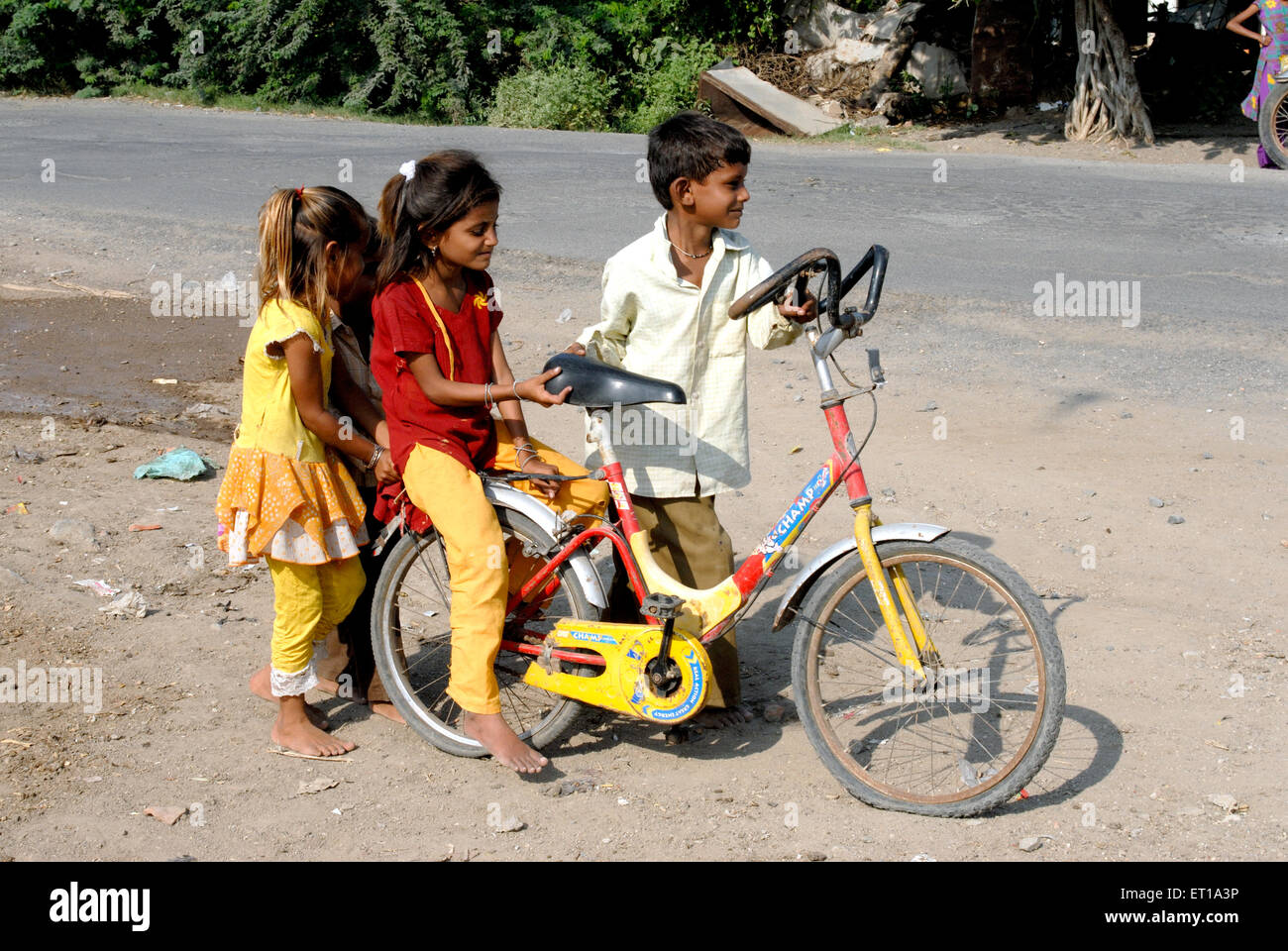 Girls and boy with bicycle, India, MR#781J;781K;781R Stock Photo - Alamy