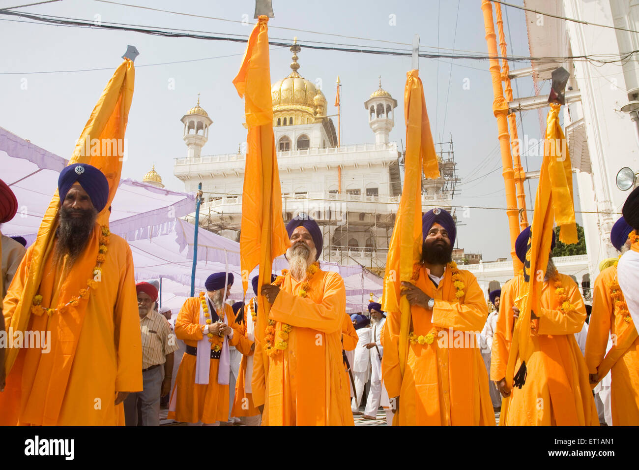 Orange color dressed Sikh men taking procession Guru Ramdas Jayanti ...