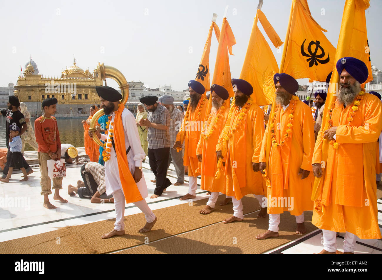 Orange color dressed Sikh men taking out the procession Guru Ramdas ...