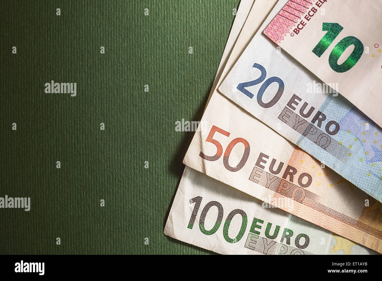 Contemporary euro banknotes on green background Stock Photo - Alamy
