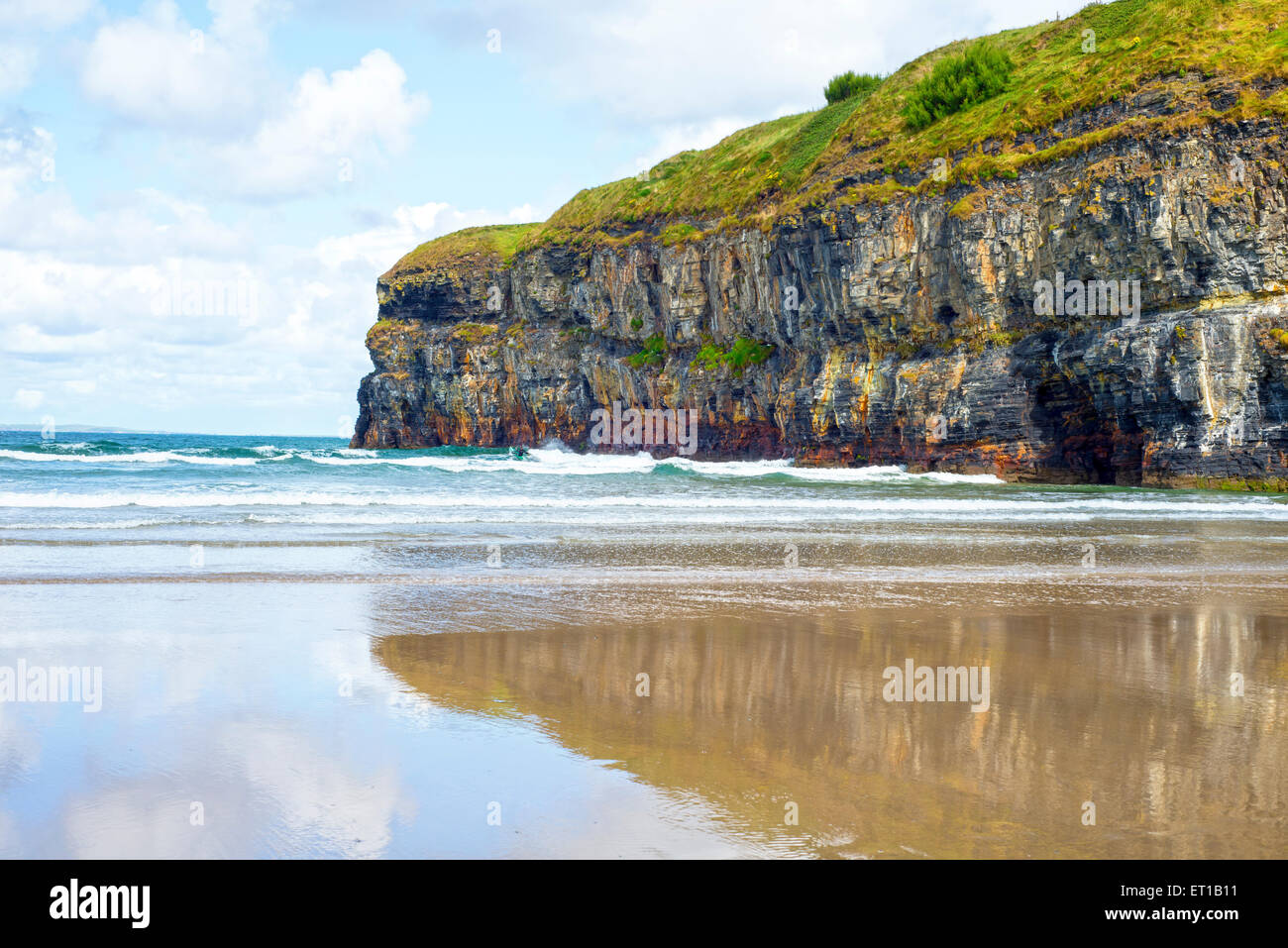 lone kayaker near the cliffs of ballybunion beach on the wild atlantic ...