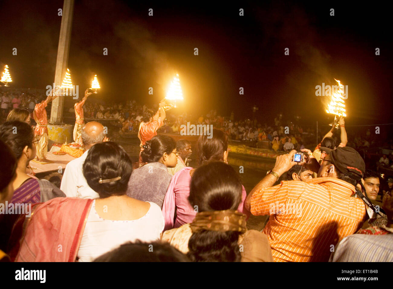 People watching Ganga aarti ; Ganguage river being worshiped fire pot ...