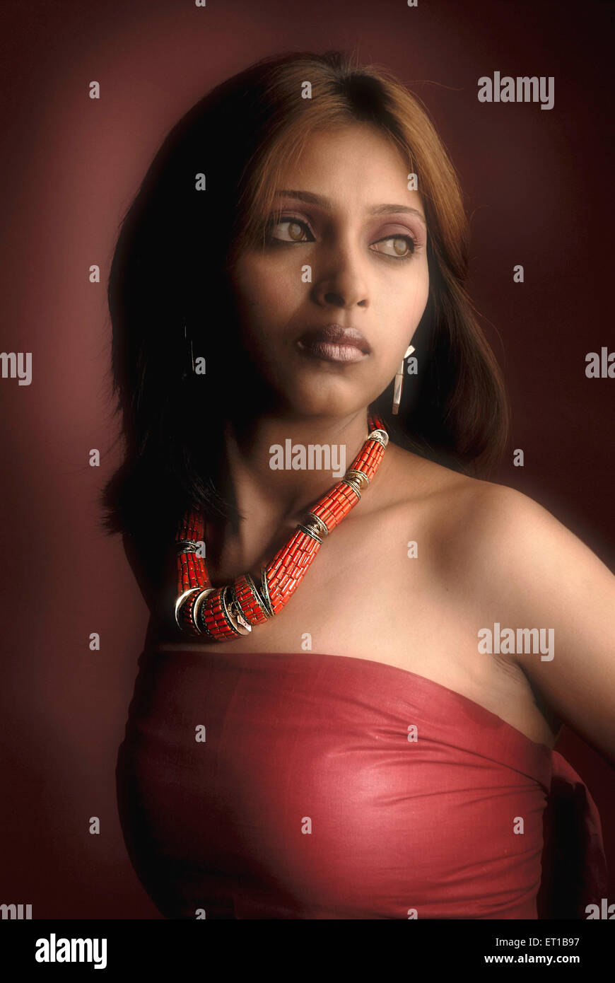 Girl in necklace of red stone and red gown ; Jodhpur ; Rajasthan ...