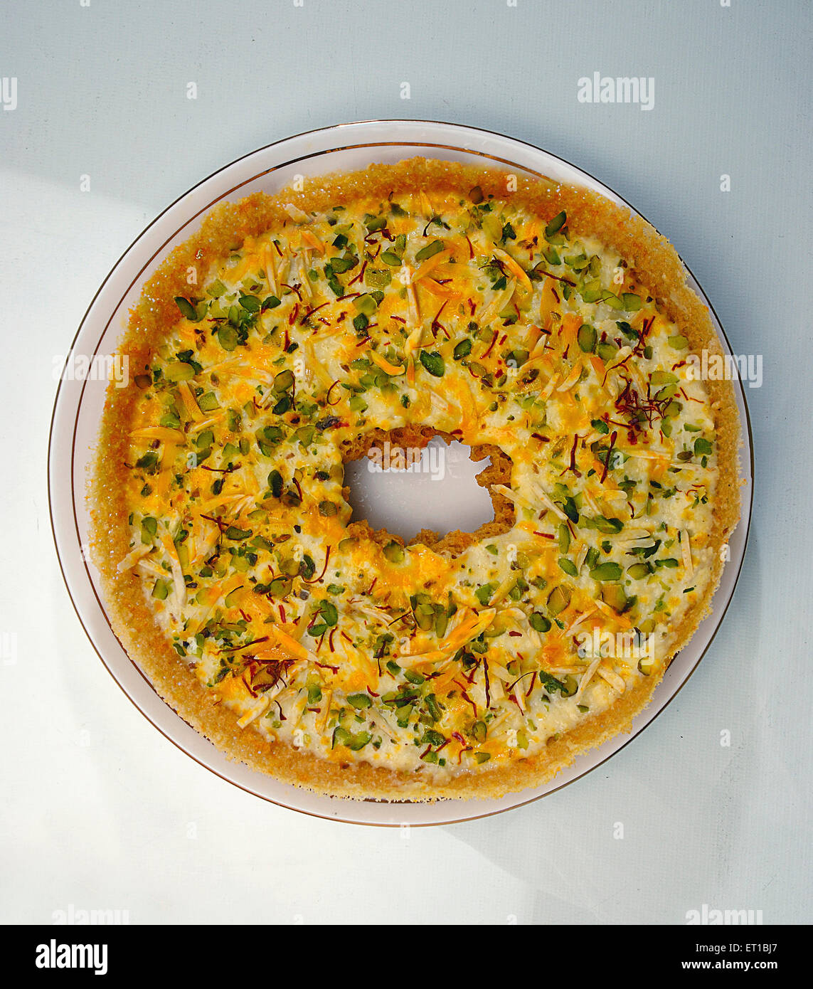 Sweet ; tabadi ghevar served in plate on white background ; Jodhpur ...