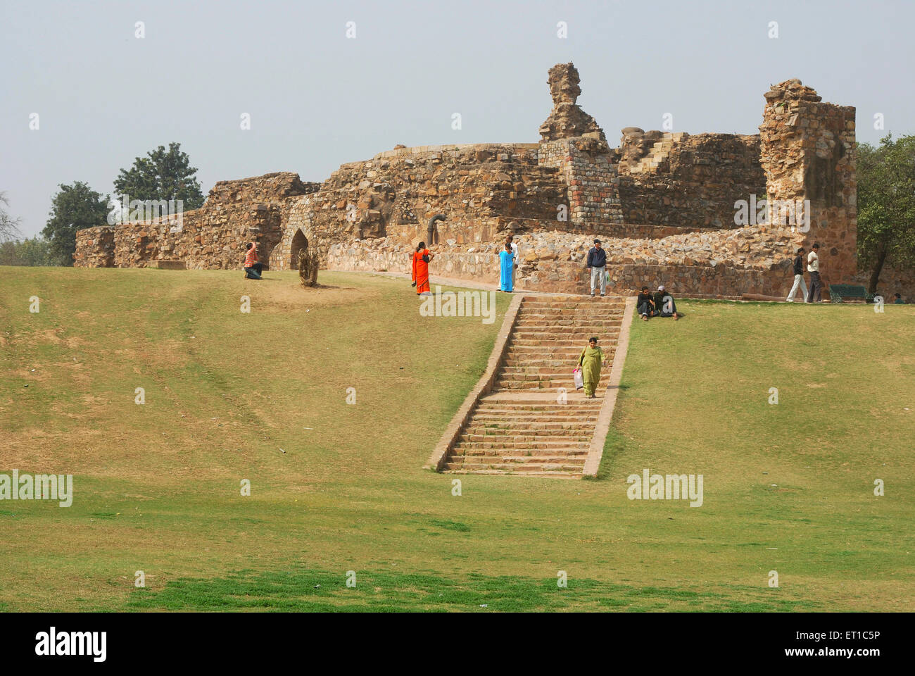 Visitors at ruins of madarsa in Qutab Minar campus ; Delhi ; India ...