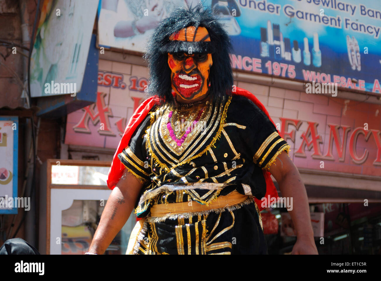 Man wearing demon costume mask ; Mahavir Jayanti procession ; Jodhpur ...