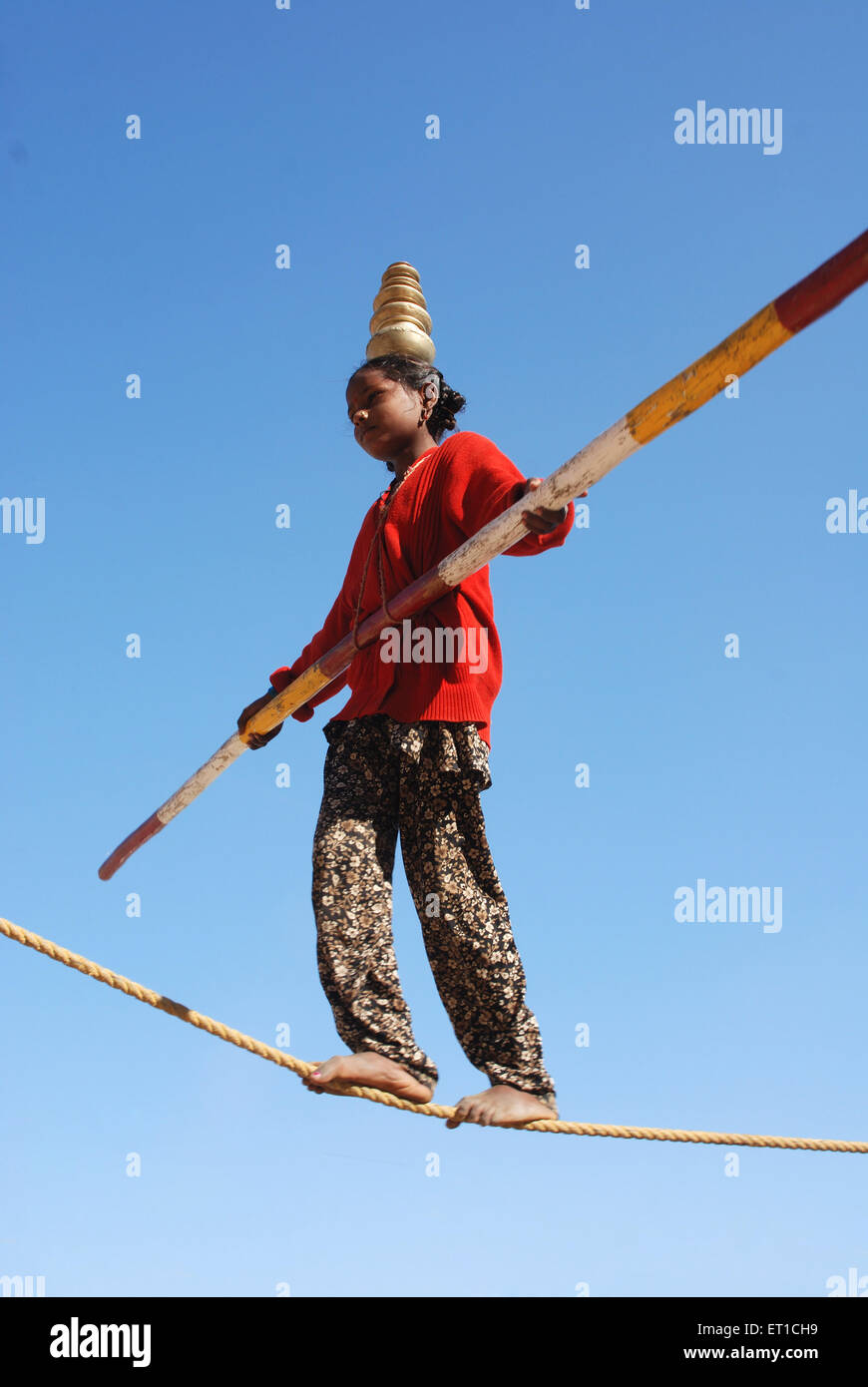 Girl performing acrobat on rope ; Jaisalmer ; Rajasthan ; India NOMR ...
