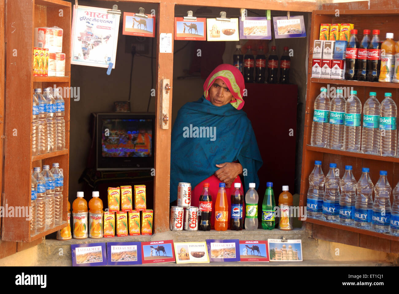 Woman shopkeeper ; water shop ; cold drink shop ; Jaisalmer ; Rajasthan ...