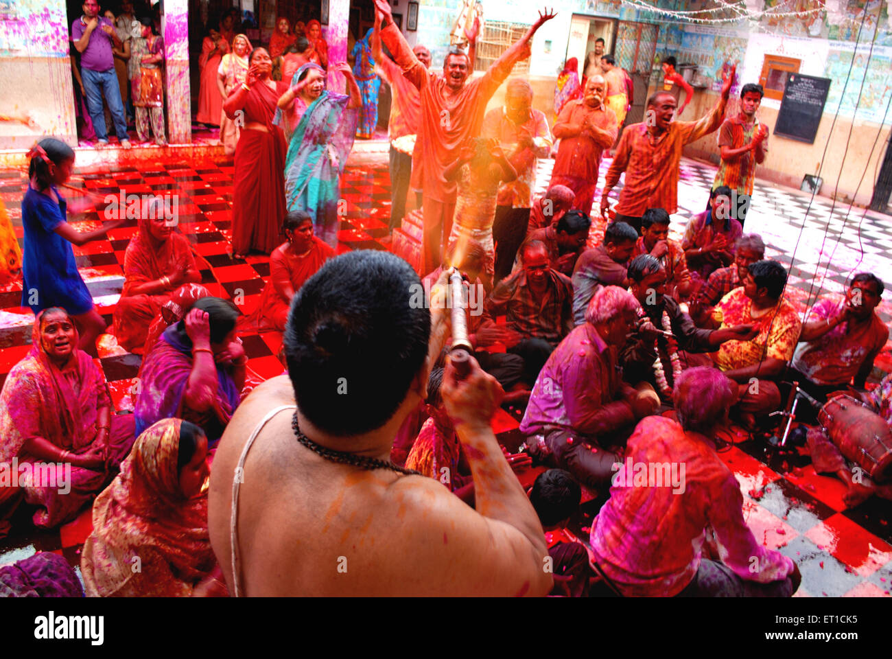 Priest playing holi with devotees in gang shyamji temple ; Jodhpur ...
