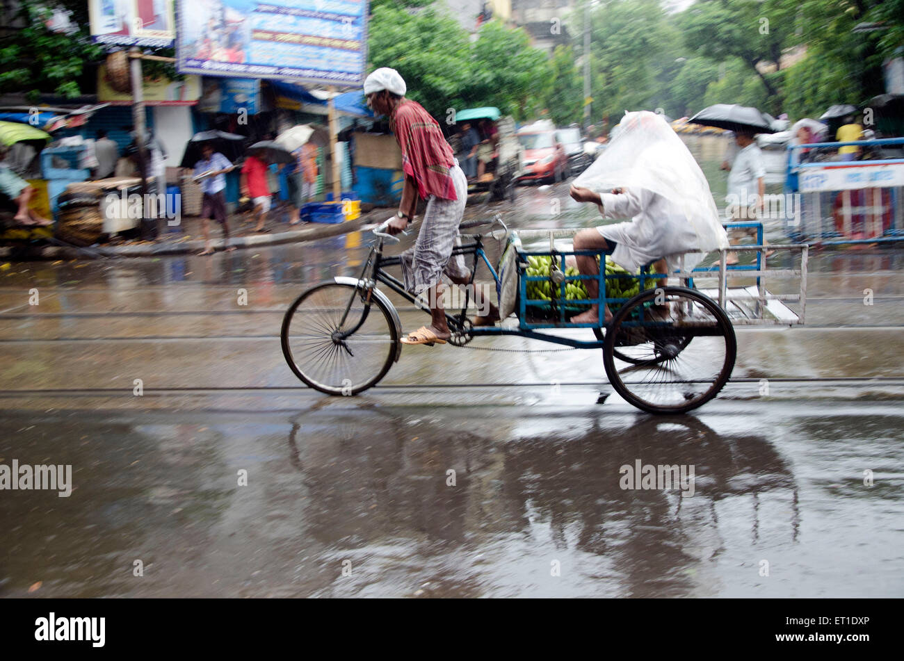 man driving tricycle with luggage on street in Kolkata West Bengal ...