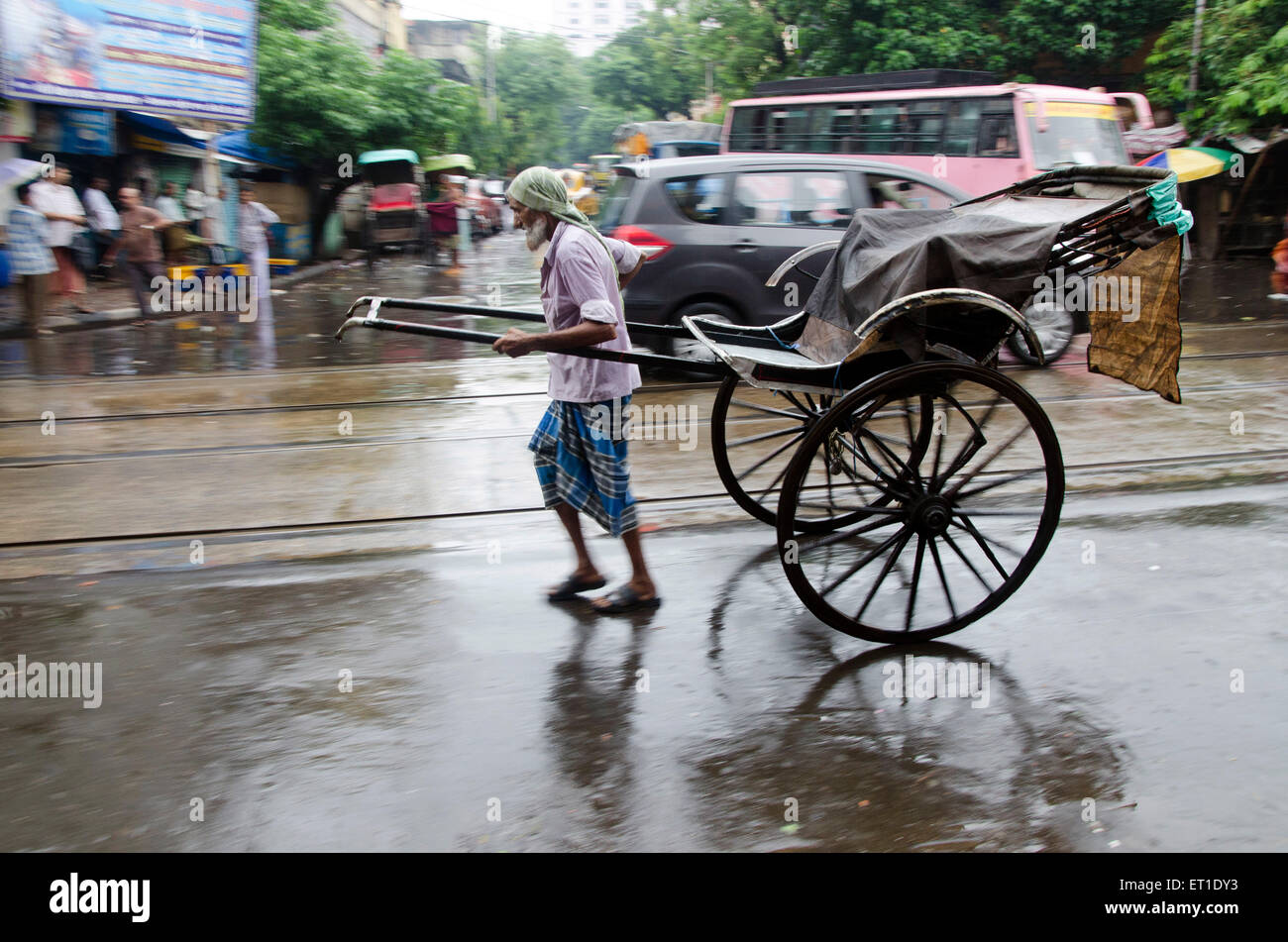 man pulling Hand Rickshaw on street in Kolkata at West Bengal India ...