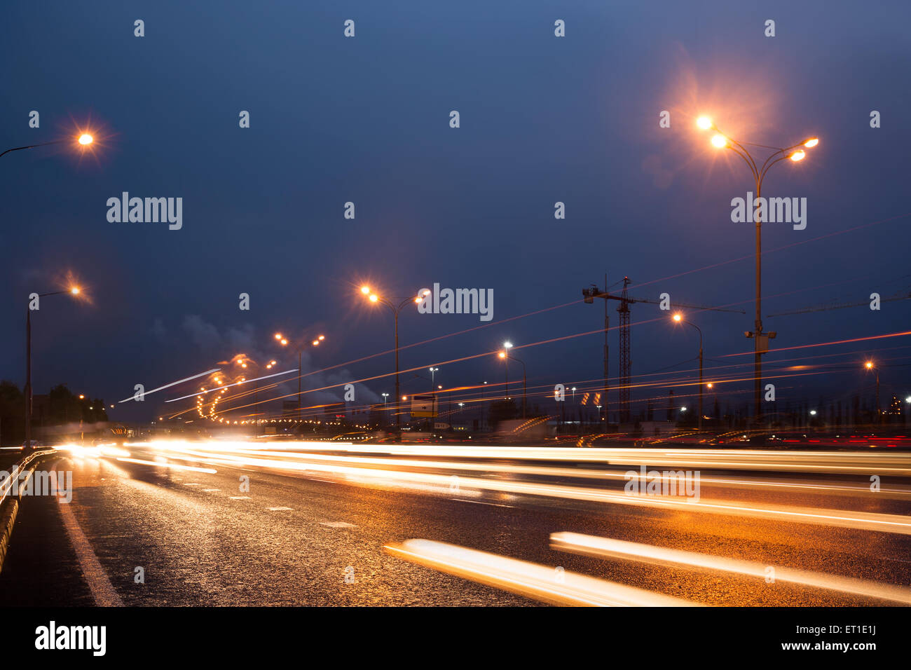 Illuminated highway at evening with light trails Stock Photo - Alamy
